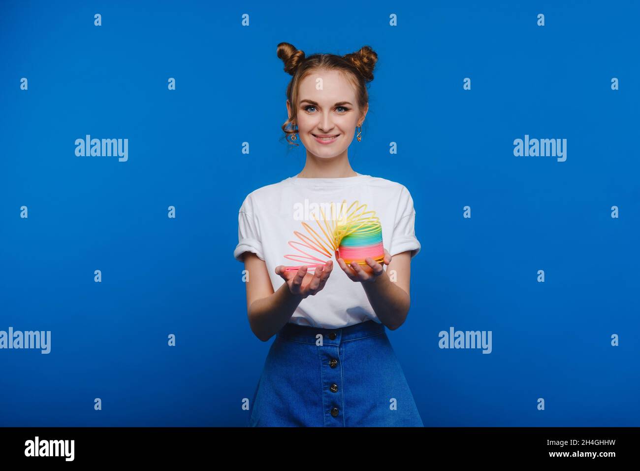 Woman playing slinky toy hi-res stock photography and images - Alamy