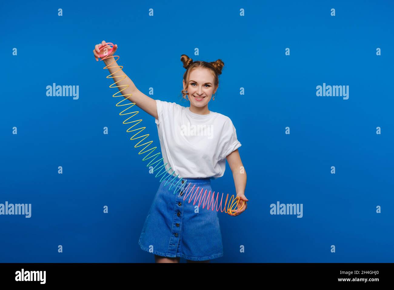 Woman playing slinky toy hi-res stock photography and images - Alamy