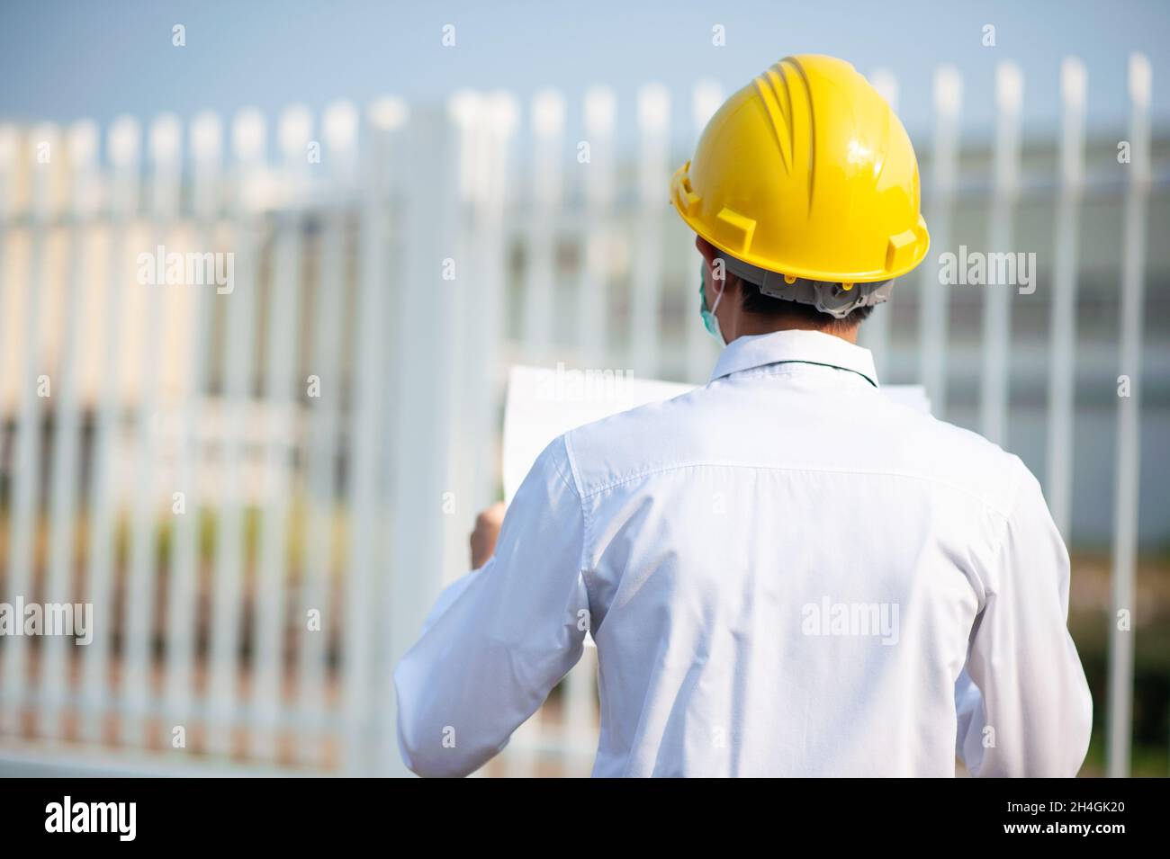 Engineer hold paper work or blueprint and survey on site construction ...