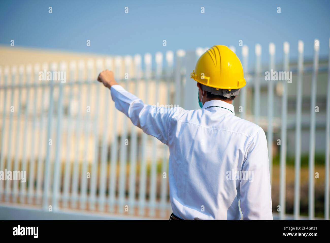 Engineer yellow helmet working outdoor Stock Photo - Alamy