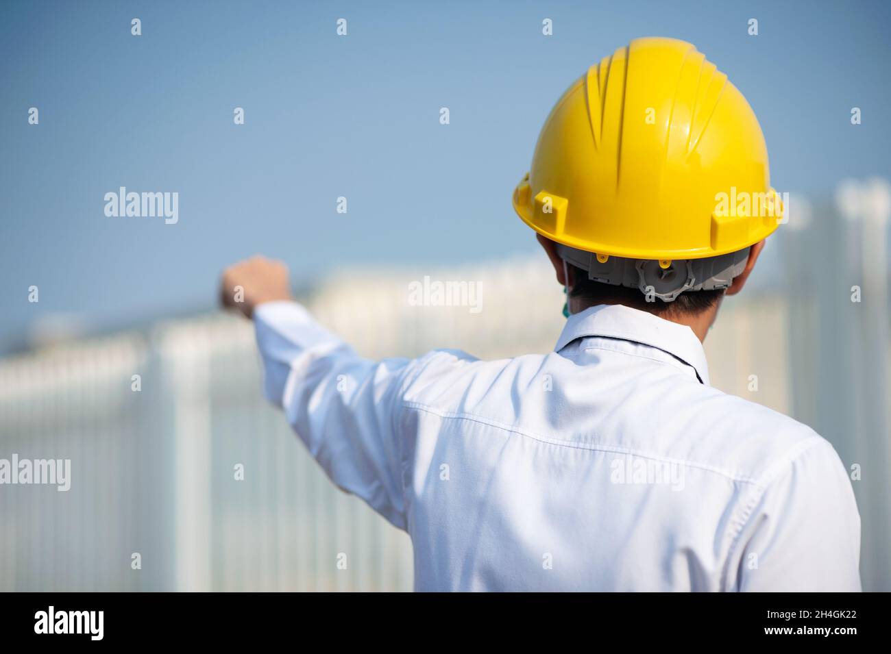 Engineer yellow helmet working outdoor Stock Photo - Alamy