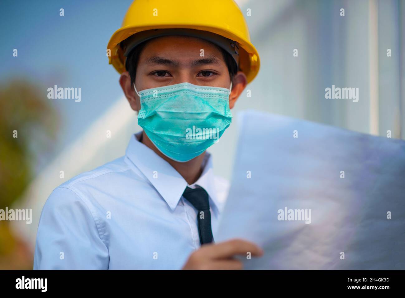 Engineer hold paper work or blueprint and survey on site construction ...
