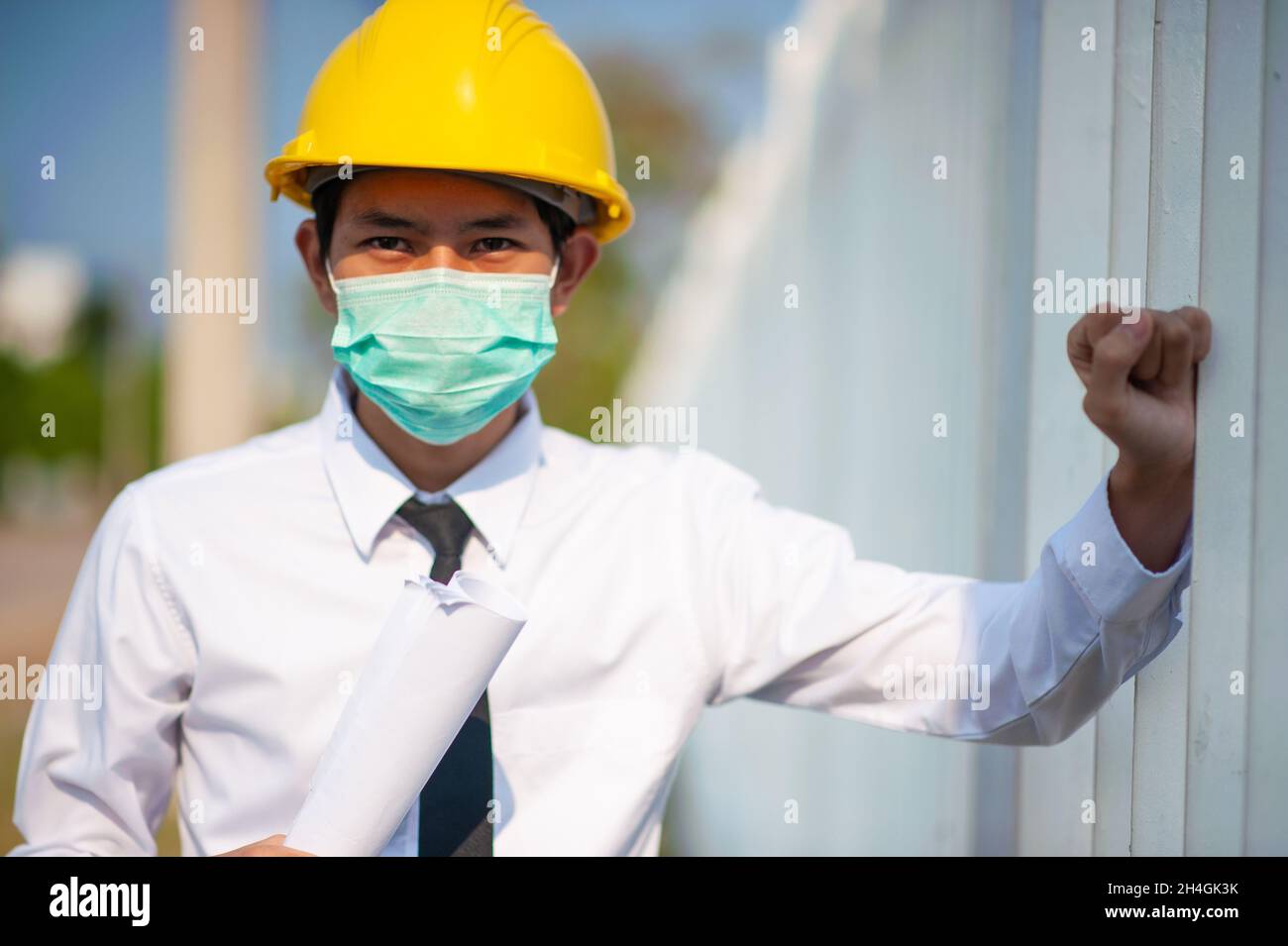 Engineer hold paper work or blueprint and survey on site construction ...