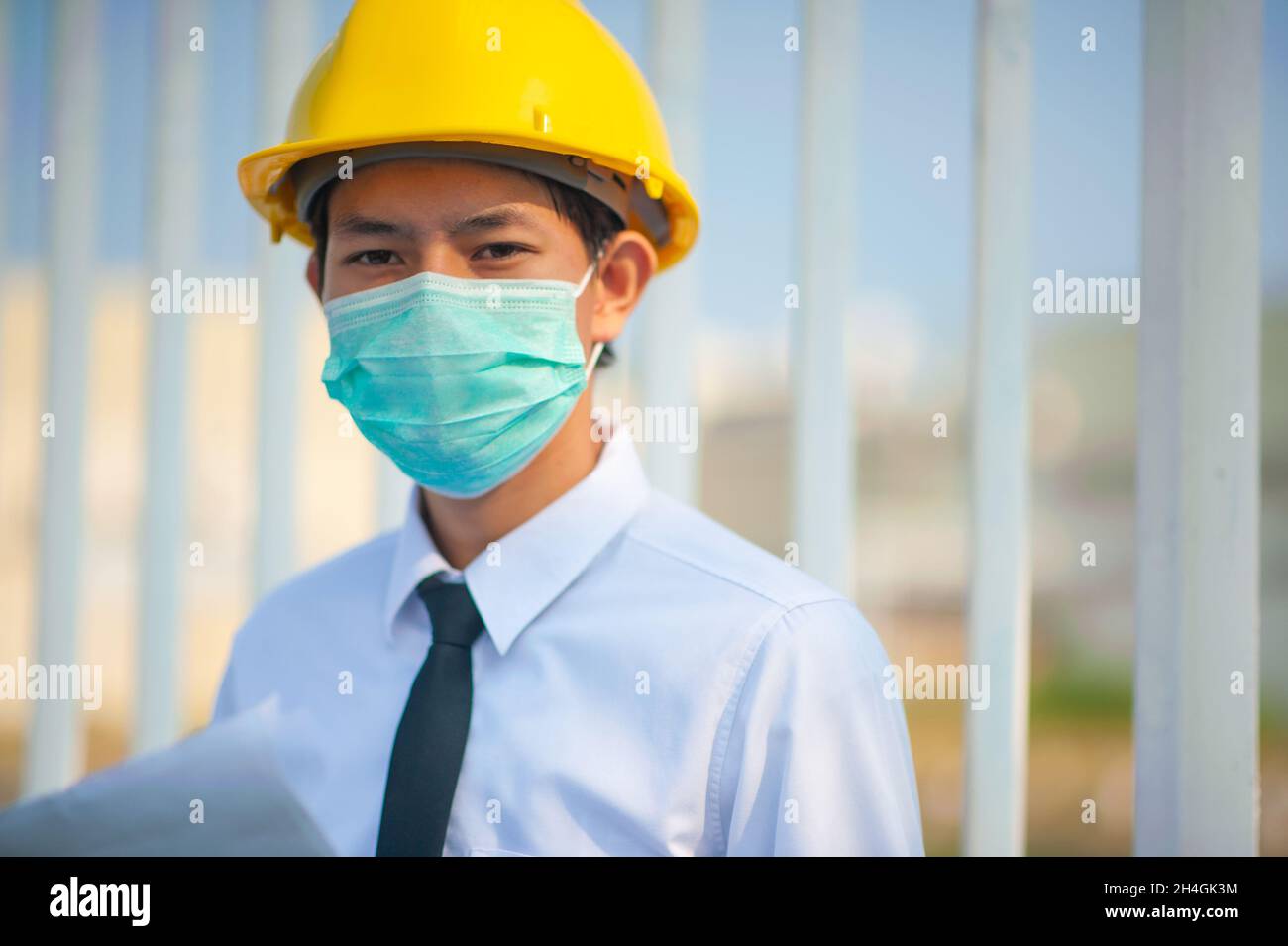 Engineer hold paper work or blueprint and survey on site construction ...
