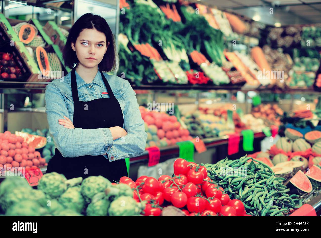 Female seller displaying assortment Stock Photo - Alamy