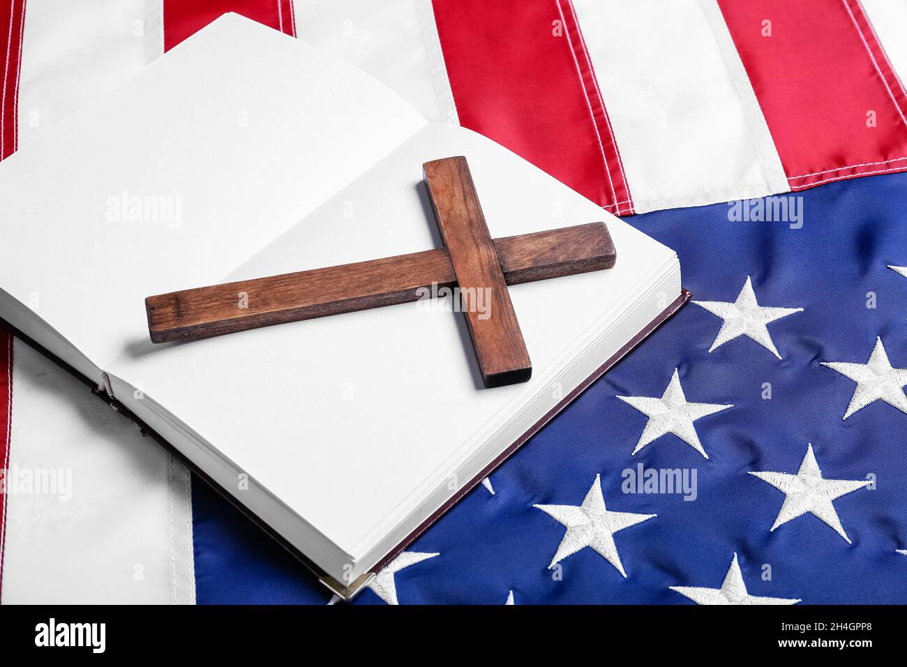 Open book with cross on USA flag Stock Photo - Alamy