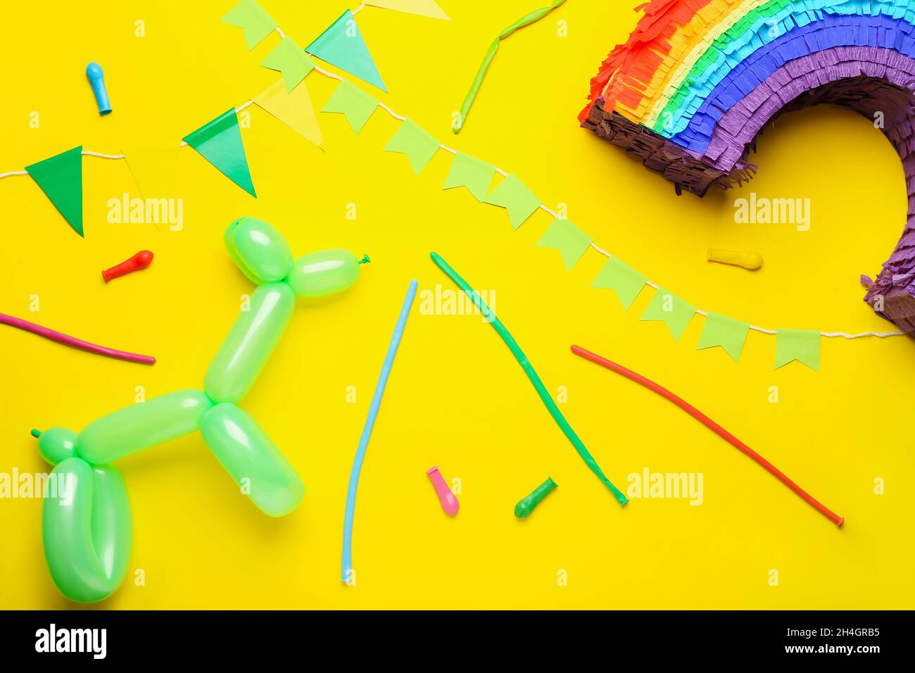 Mexican pinata and dog made of balloon on yellow background Stock Photo ...