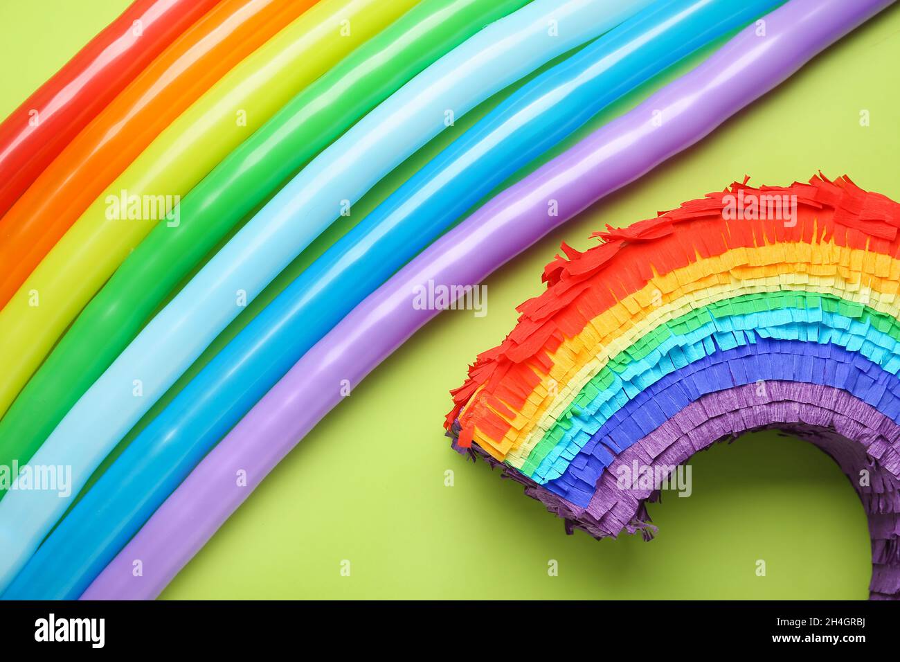 Mexican pinata and colorful balloons on green background Stock Photo ...
