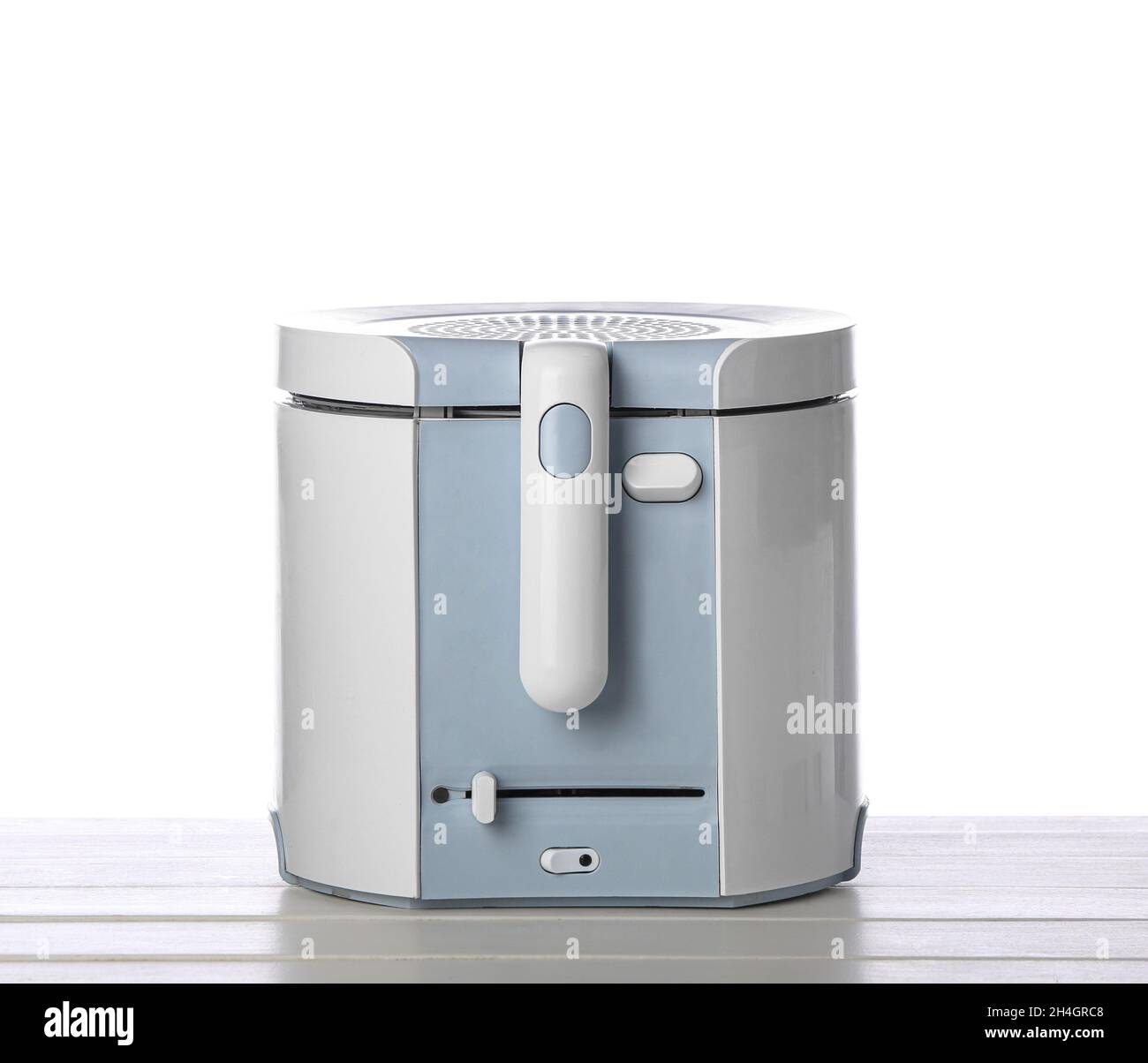 Modern deep fryer on table against white background Stock Photo - Alamy