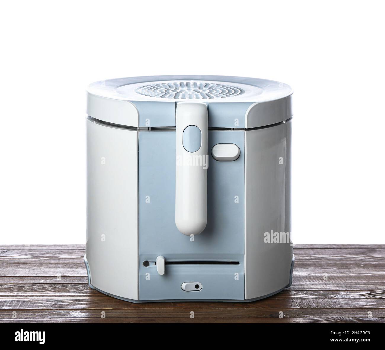Modern deep fryer on table against white background Stock Photo - Alamy
