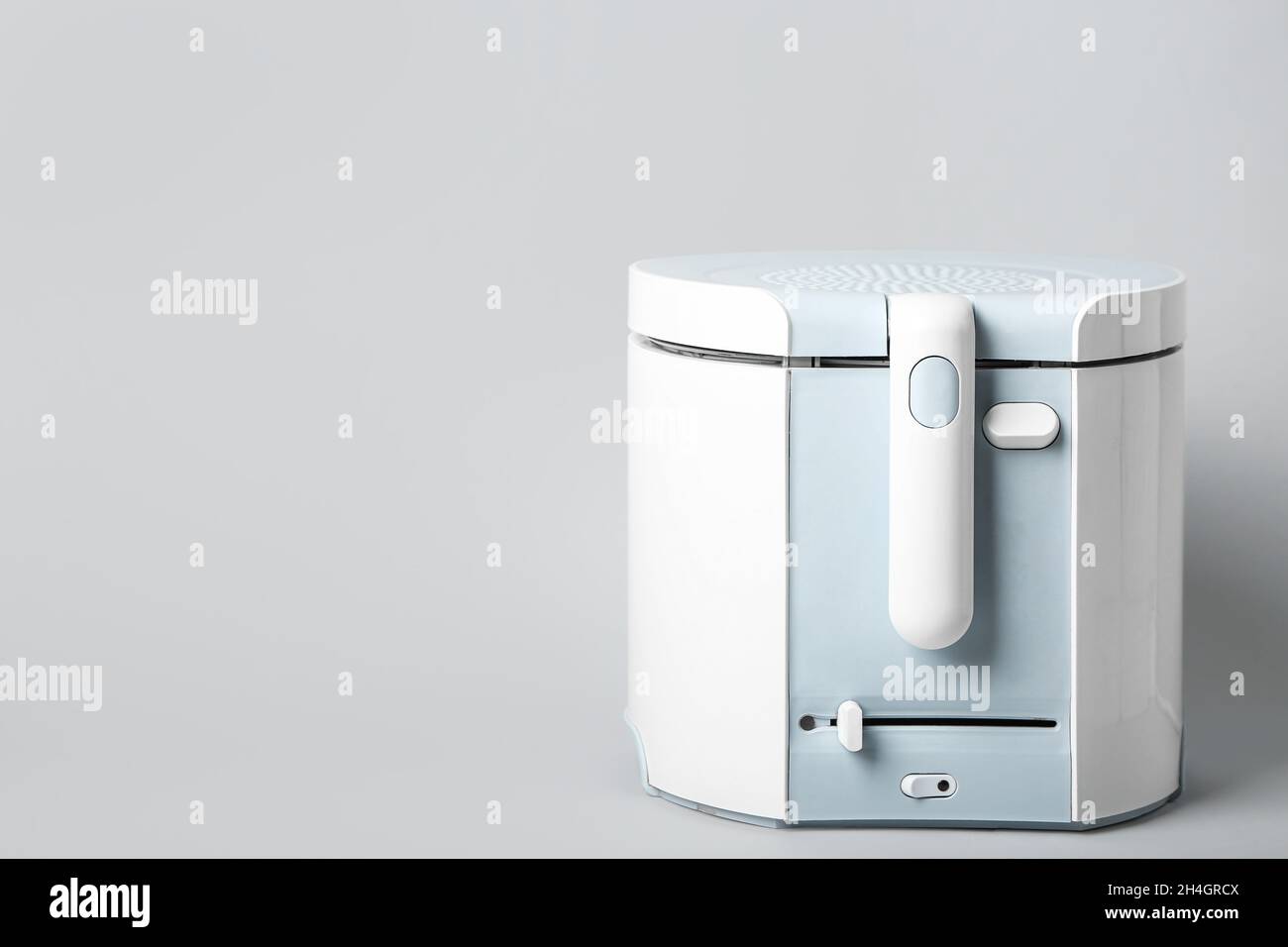 Modern deep fryer on light background Stock Photo - Alamy
