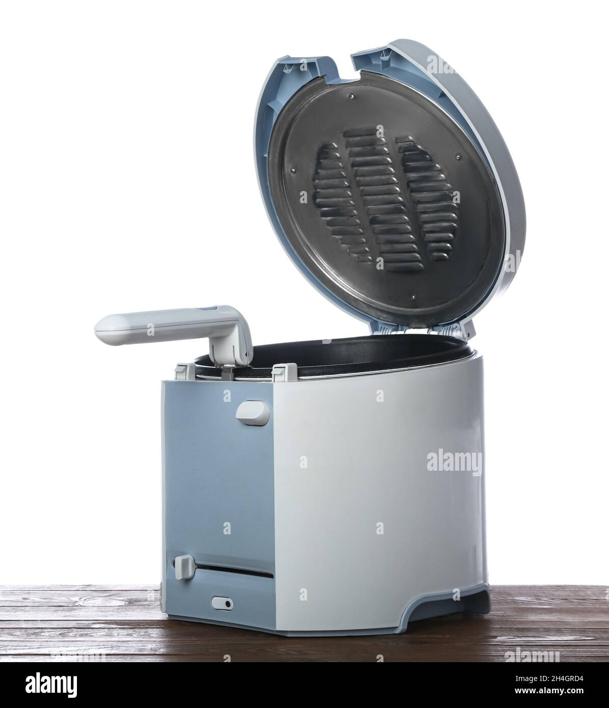 Modern deep fryer on table against white background Stock Photo - Alamy