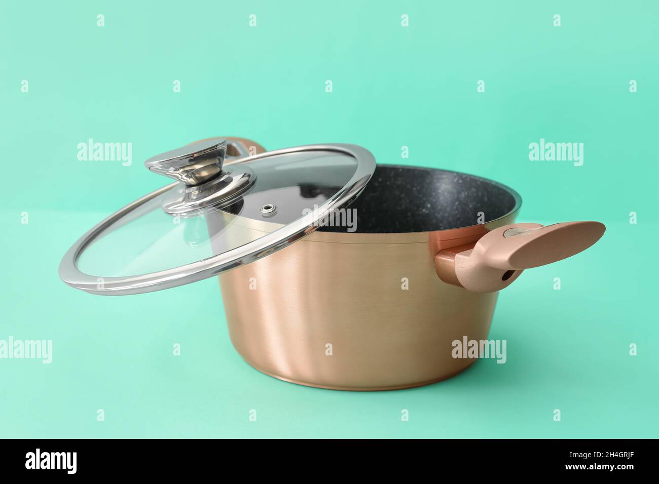 Iron cooking pot with lid on color background Stock Photo - Alamy