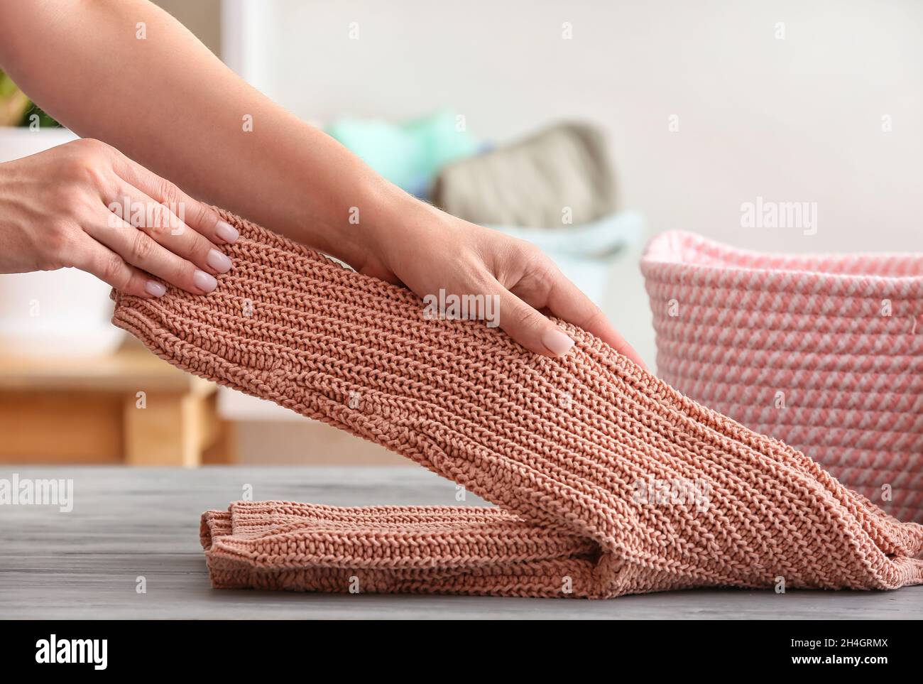 Woman folding clean clothes hi-res stock photography and images - Alamy