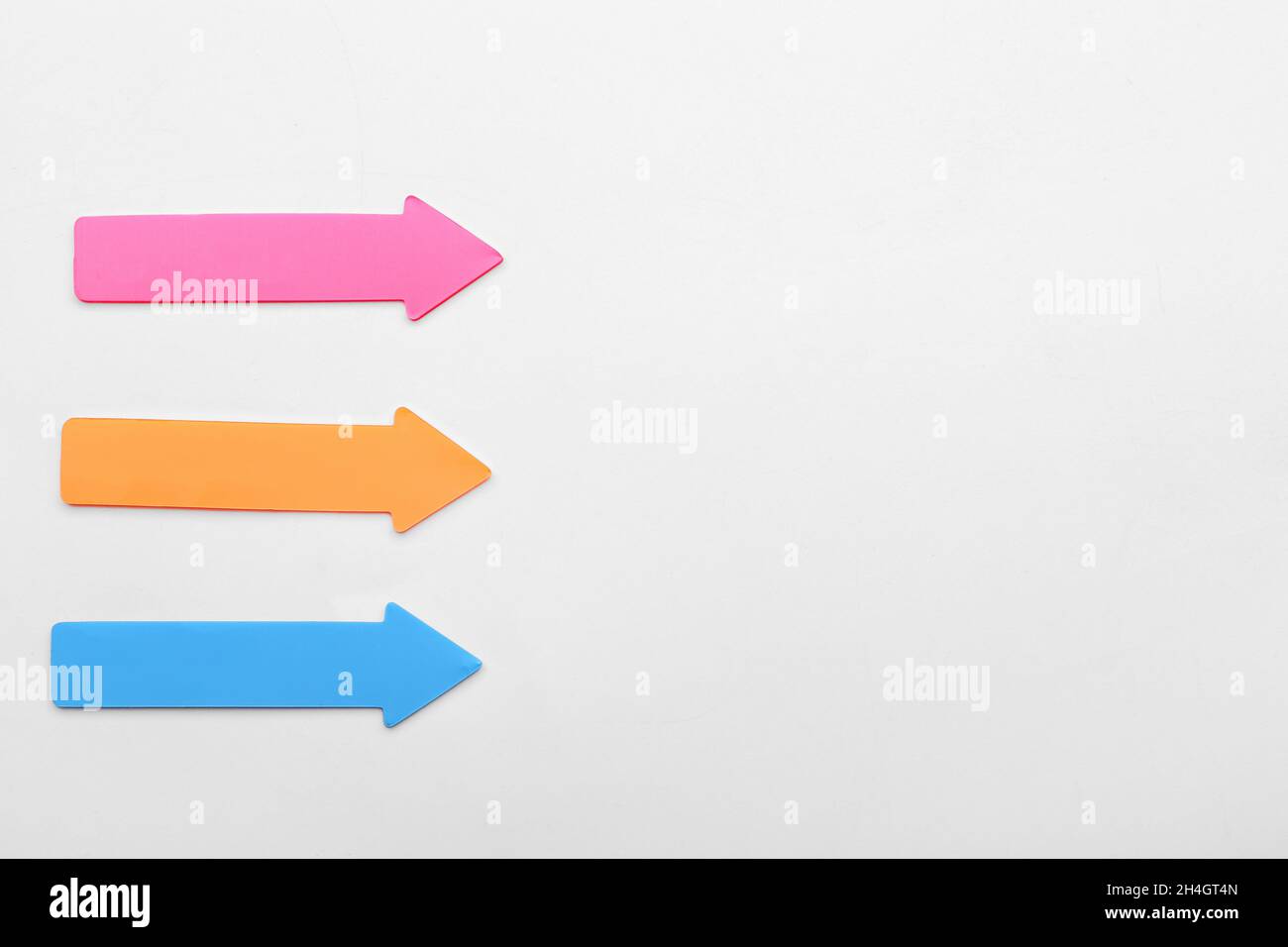 Colorful sticky notes in shape of arrows on white background Stock ...