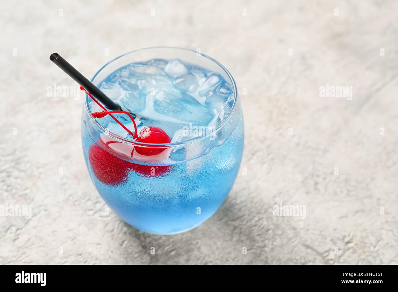 Glass of Blue Lagoon cocktail on light background, closeup Stock Photo ...