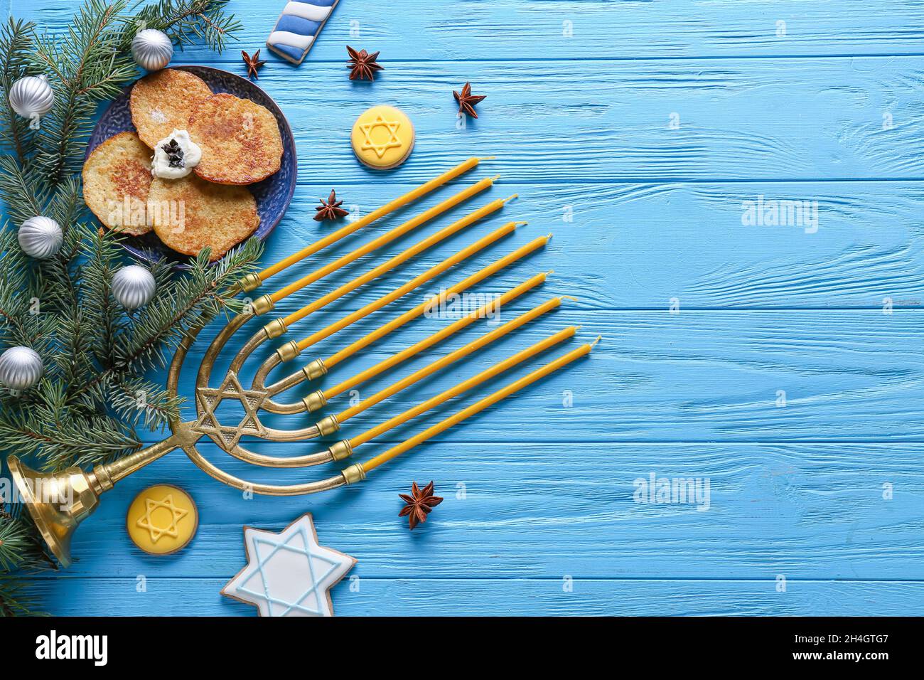 Symbols of Hanukkah and Christmas decor on color wooden background ...