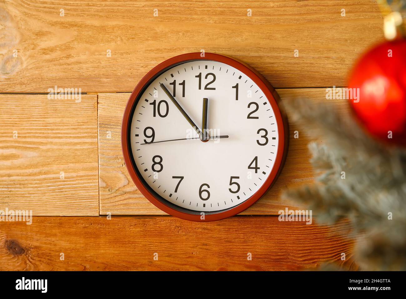 Christmas tree and clock on wooden wall Stock Photo - Alamy