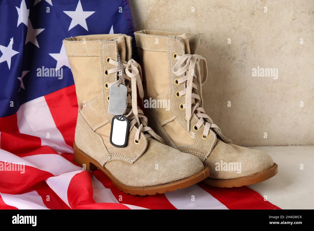 Military boots, tags and USA flag on light background Stock Photo - Alamy
