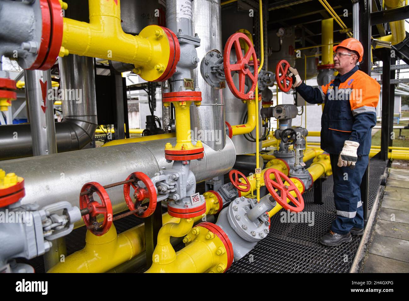 Gas station worker controls gas valve at a natural gas station during ...