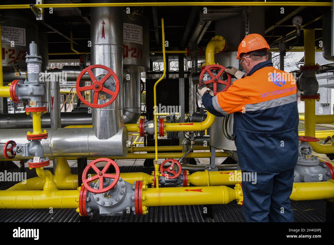 Gas station worker controls gas valve at a natural gas station during ...