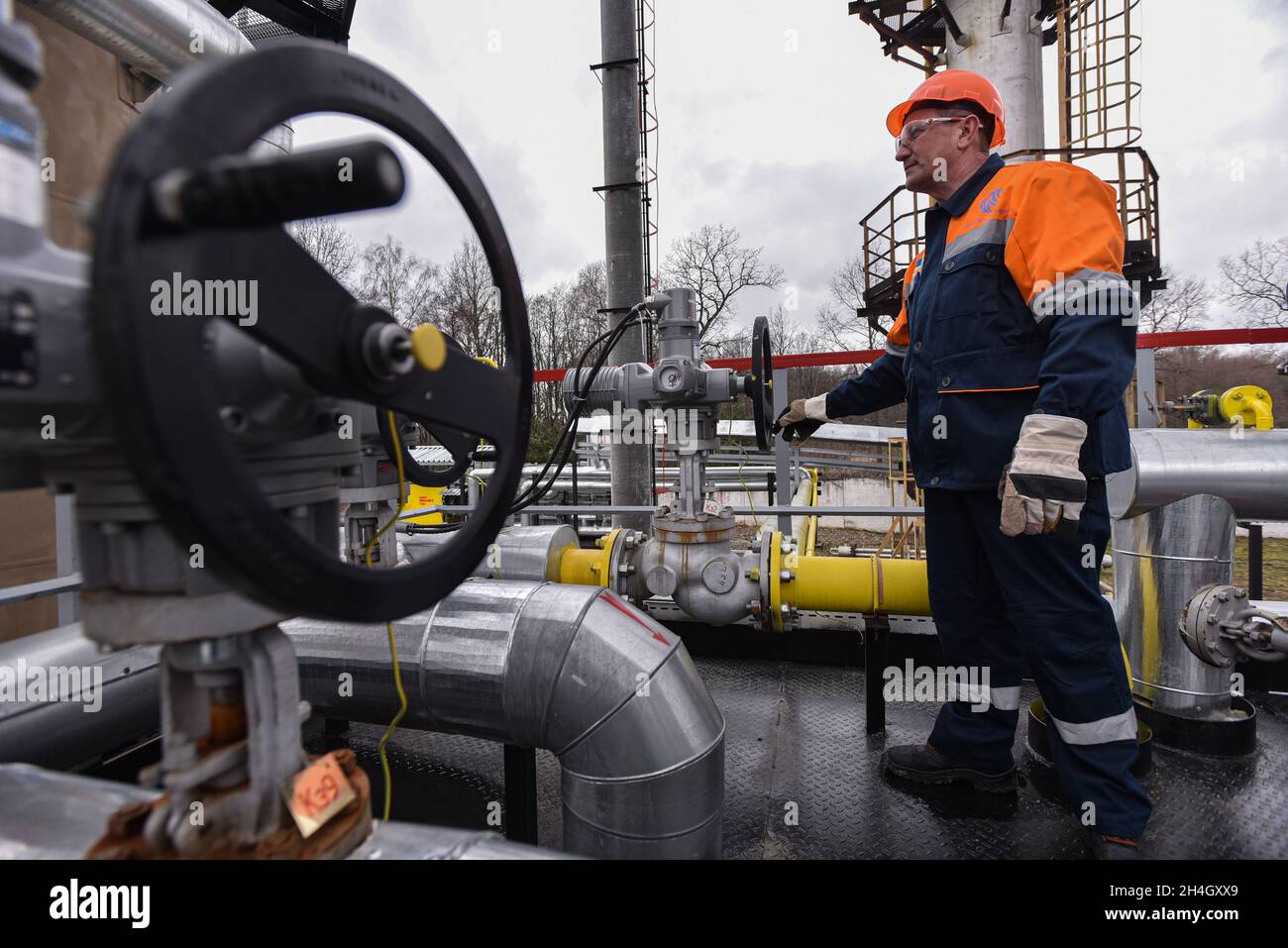 Gas station worker controls gas valve at a natural gas station during ...