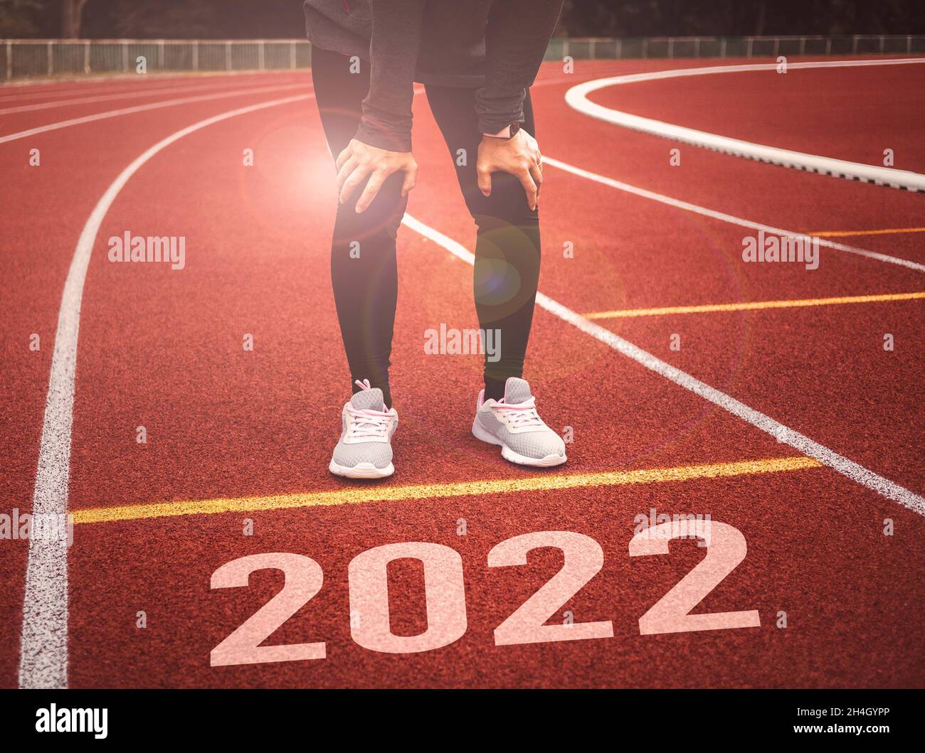 Athletic women in sport clothes on starting line prepares to run at the ...