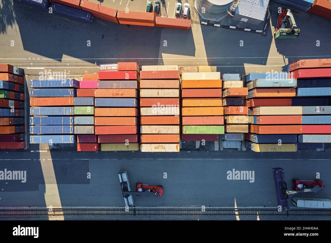 Containers warehouse on platform with cranes and forklifts, aerial view ...
