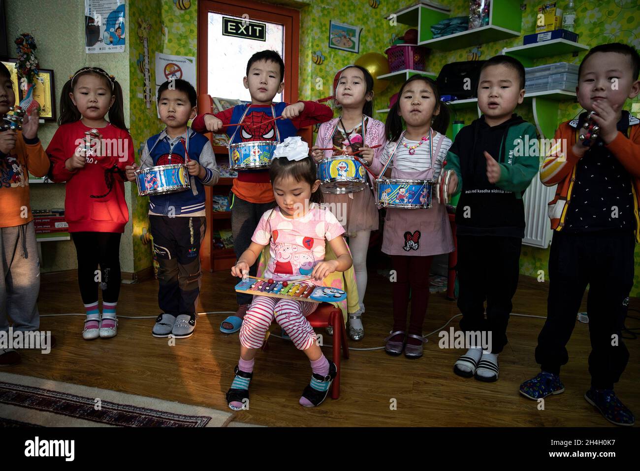 Children perform during a music class in a kindergarten in one of the ...