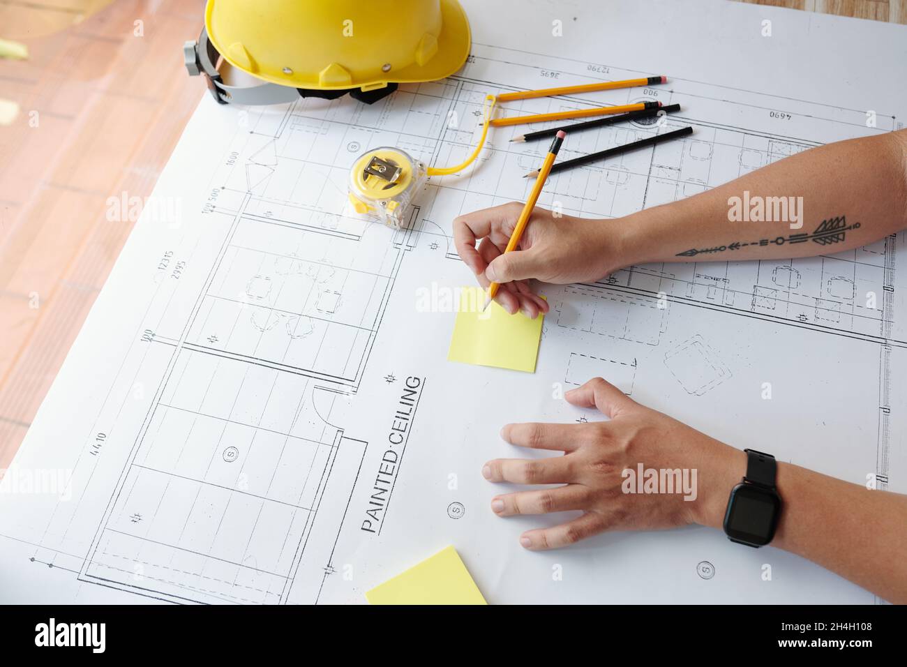 Civil engineer working on construction plan of building and taking ...