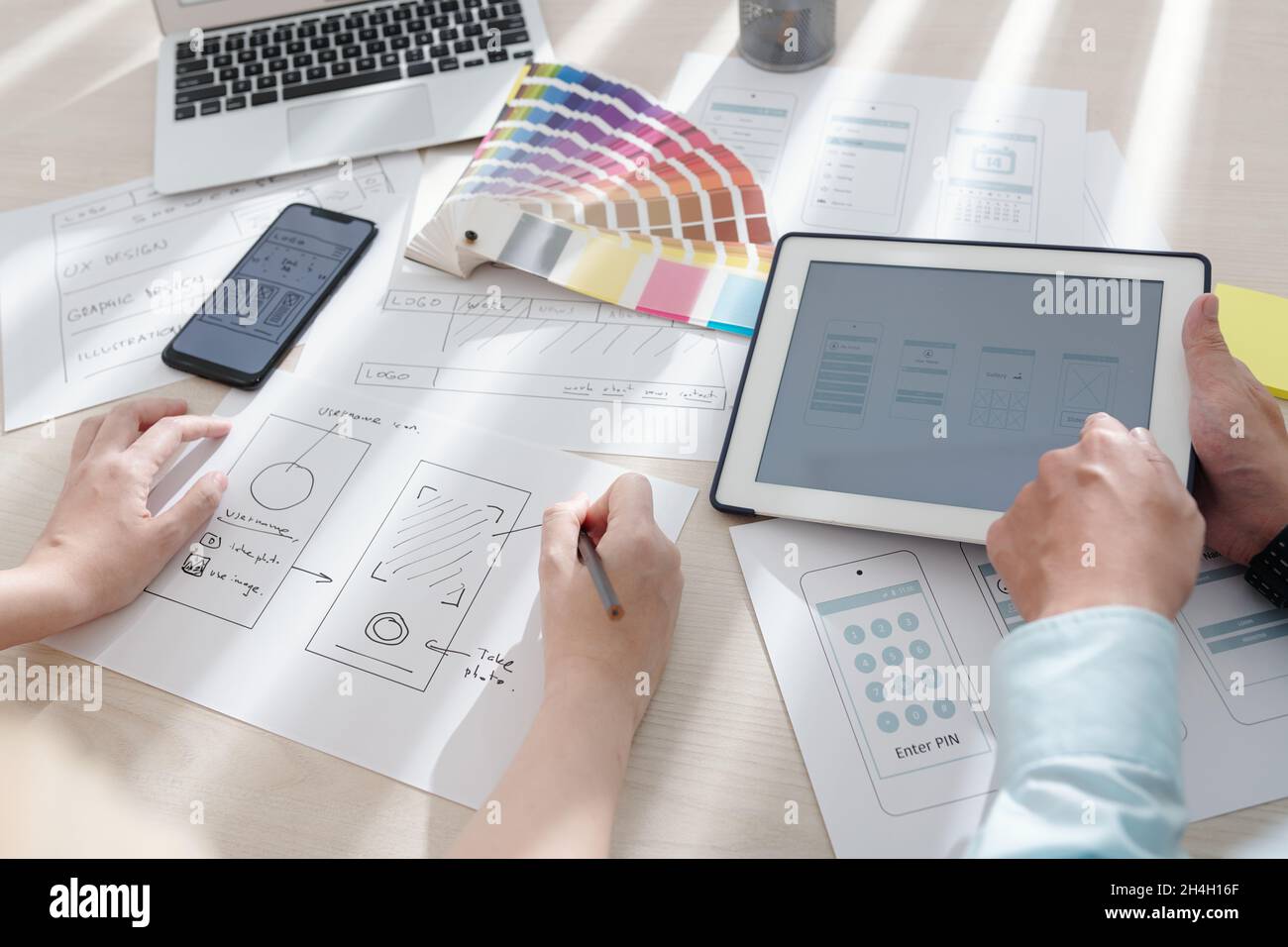 UI and UX designers working on design of mobile application, drawing ...