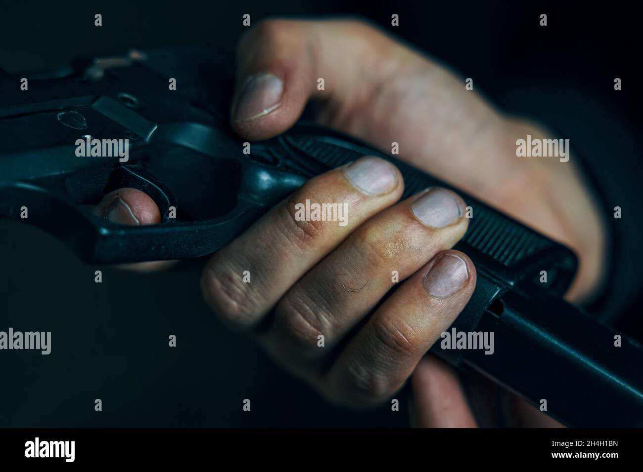Man inserts drum of cartridges into pistol. Reloading gun close-up ...