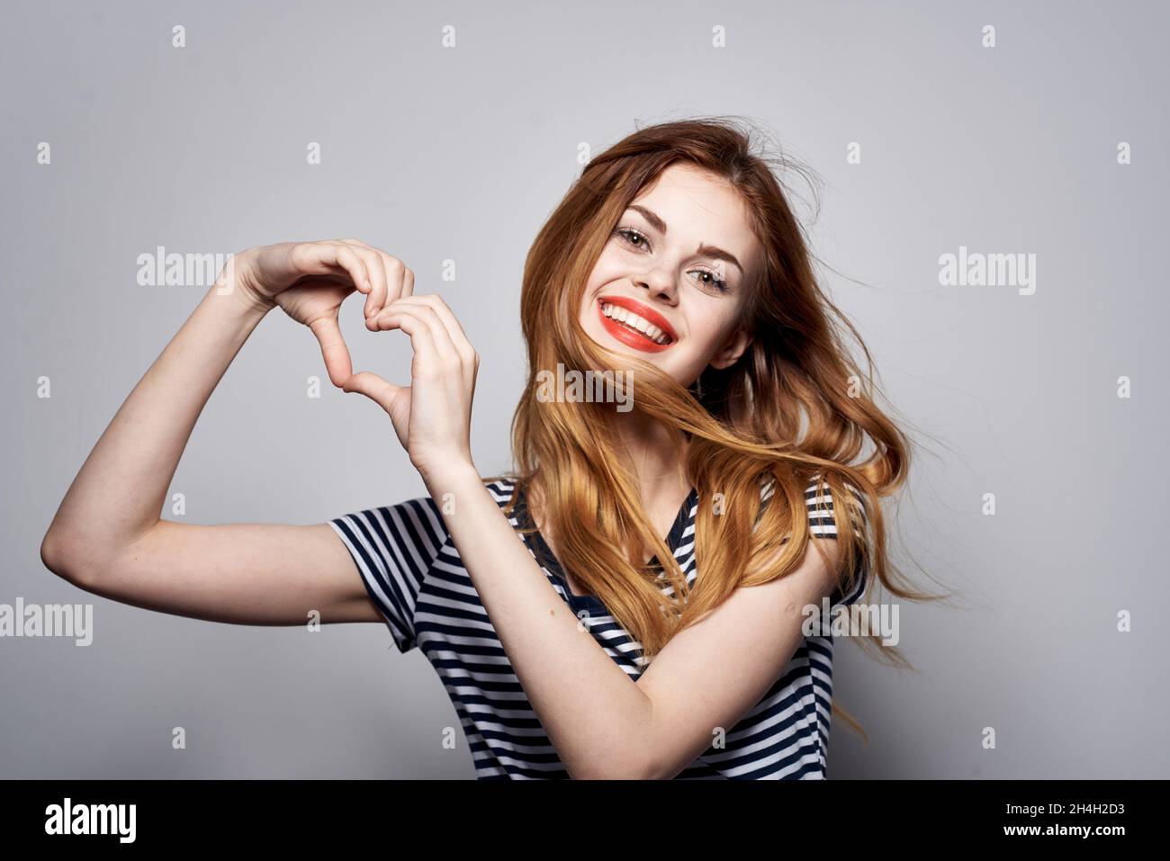 cheerful woman holding hair makeup posing fun fashion model studio ...