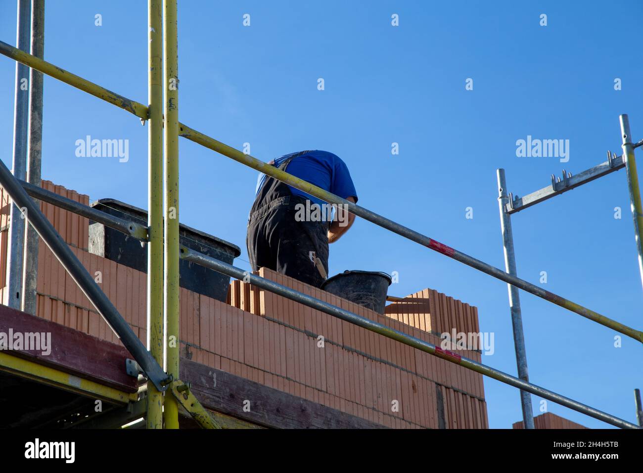 Construction worker (bricklayer) works on the construction site Stock ...