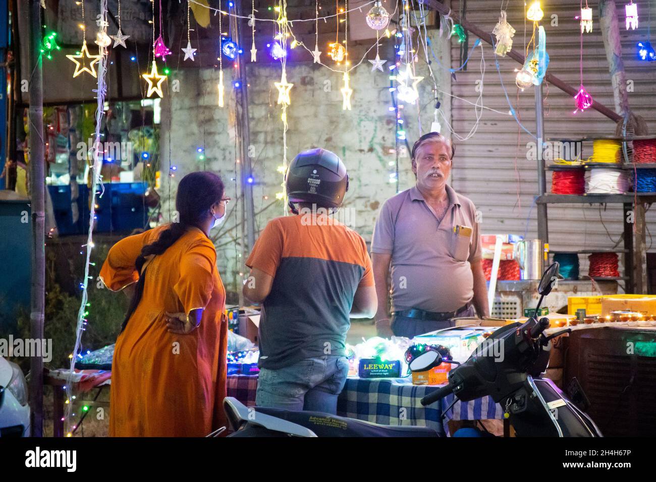 old shopkeeper shop decorated with lights on teh hindu festival of ...