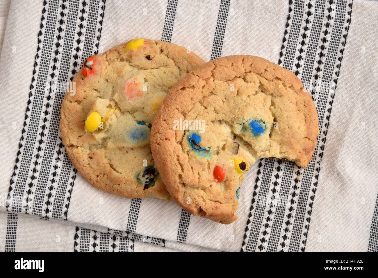 Gourmet sugar cookies with chocolate candy with a misssing bite ...