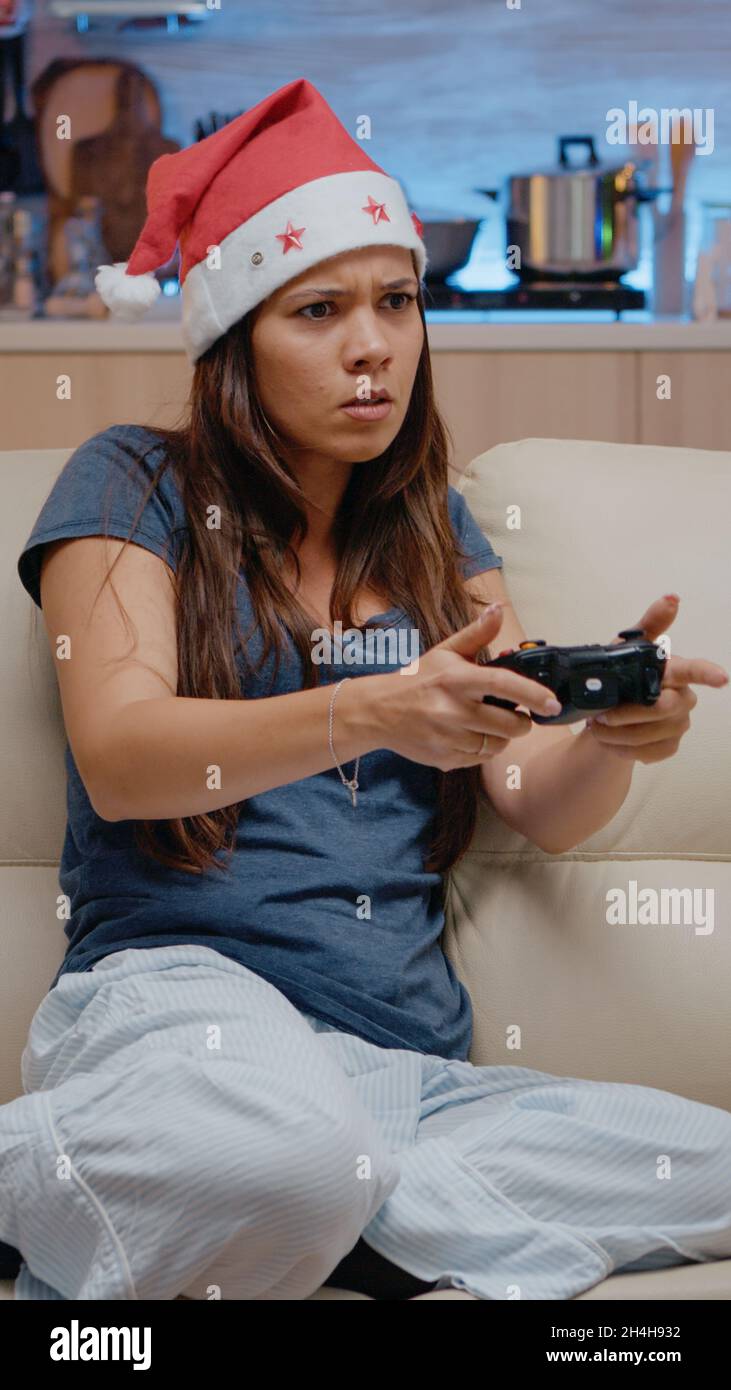 Unhappy adult losing at video games with joystick on tv console. Woman ...