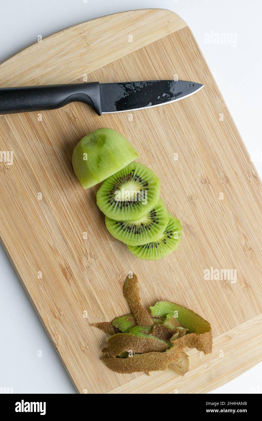 Green fresh kiwi and wood board on a table. Flat lay, top view Stock ...
