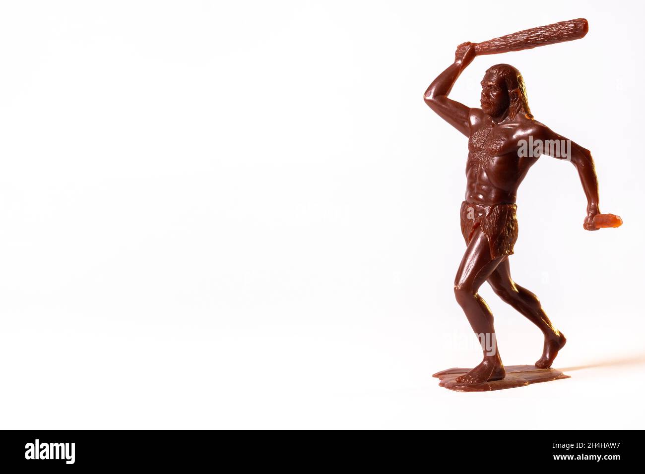 Large toy figures of primitive people on a white background Stock Photo ...