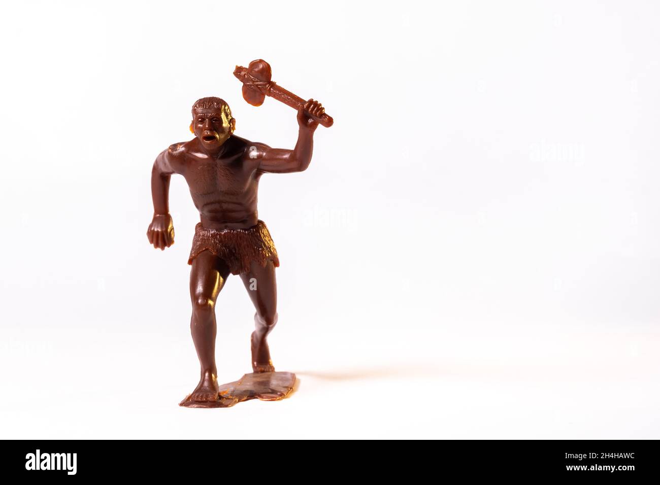 Large toy figures of primitive people on a white background Stock Photo ...