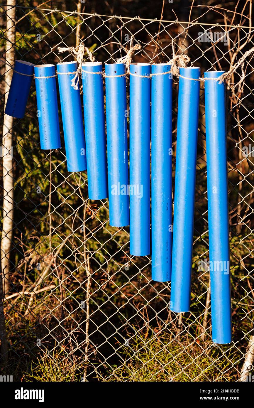 old blue plastic pipes that have been turned into musical instruments ...