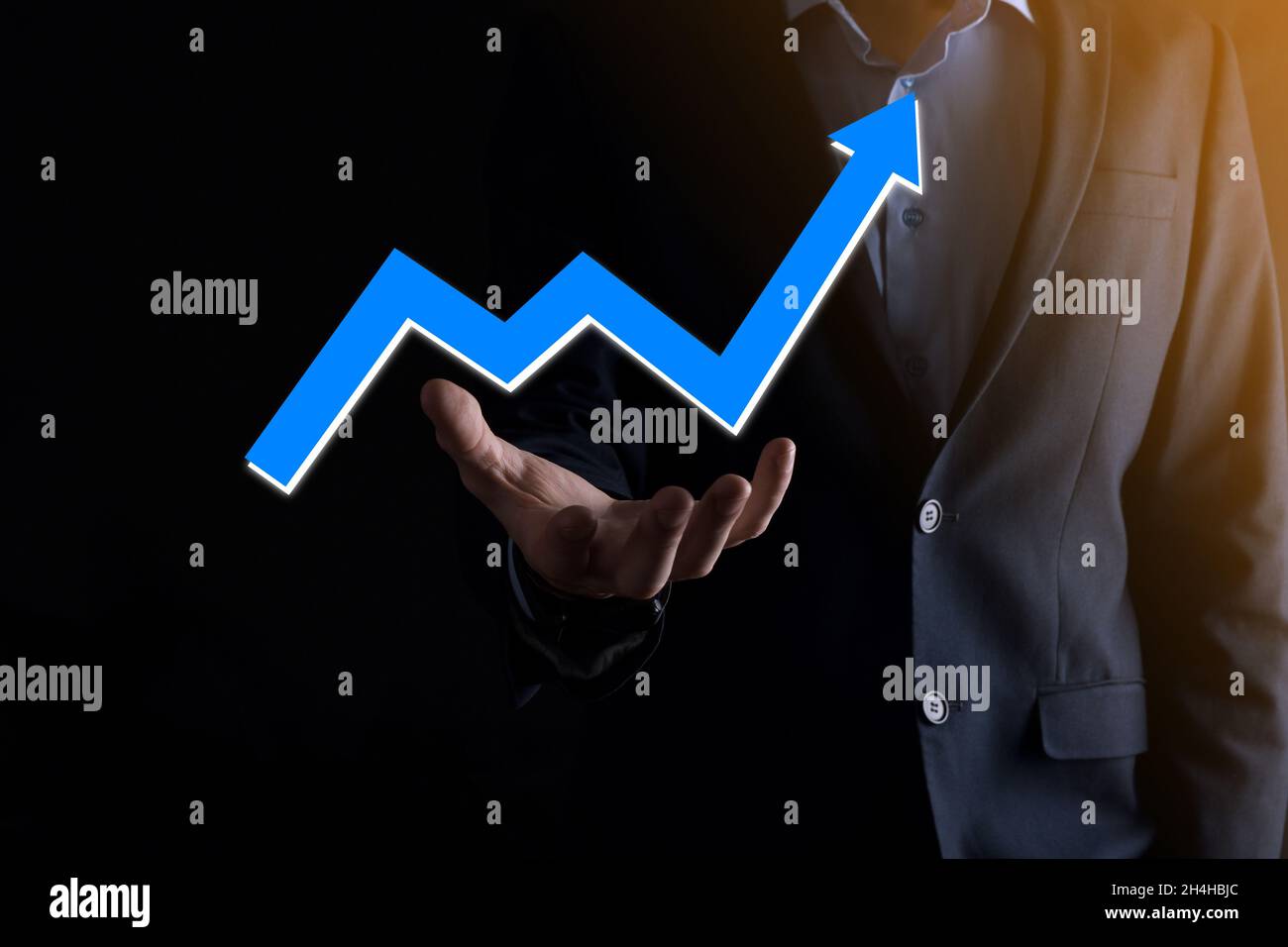 Businessman man holding a graph with positive profits growth. plan ...