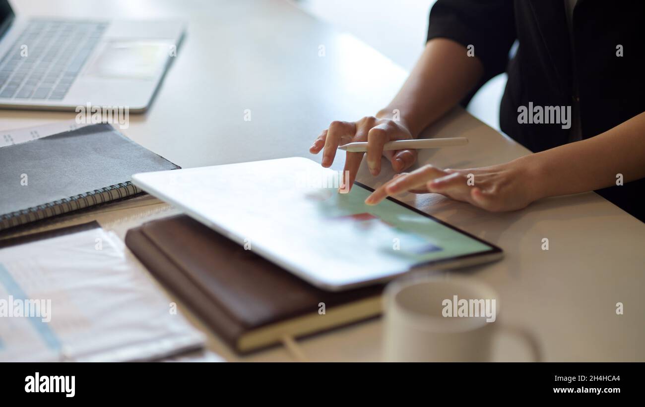 Crop image of business female entrepreneur working on tablet, using her ...