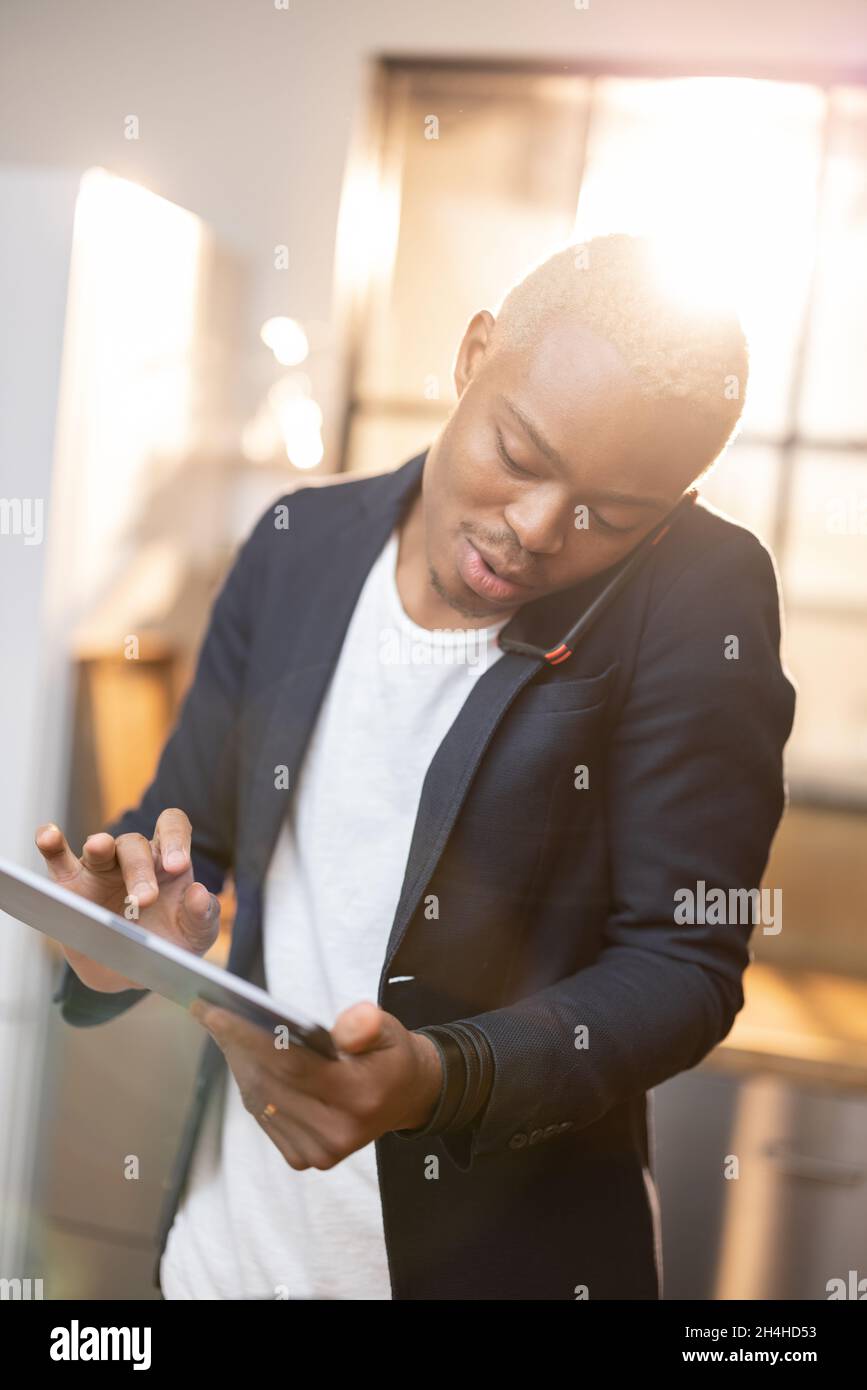 Black man watching something on smartphone Stock Photo - Alamy