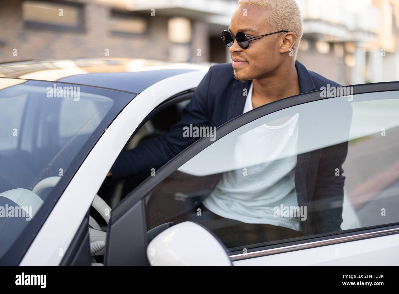 Businessman opening his car Stock Photo - Alamy