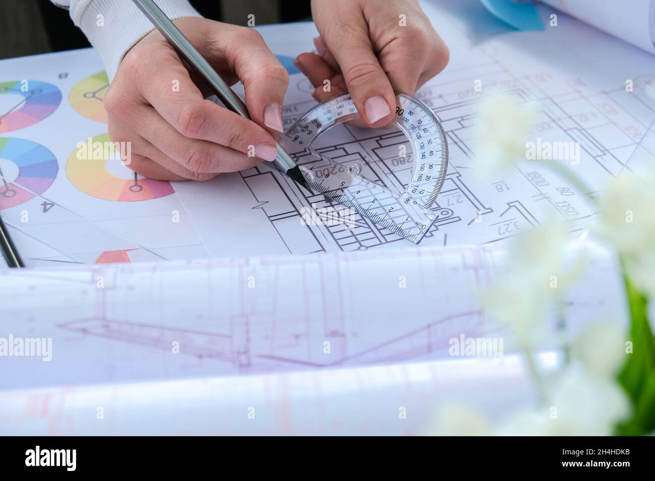 Hands use pencil with a protractor. Architectural Project drawings with ...