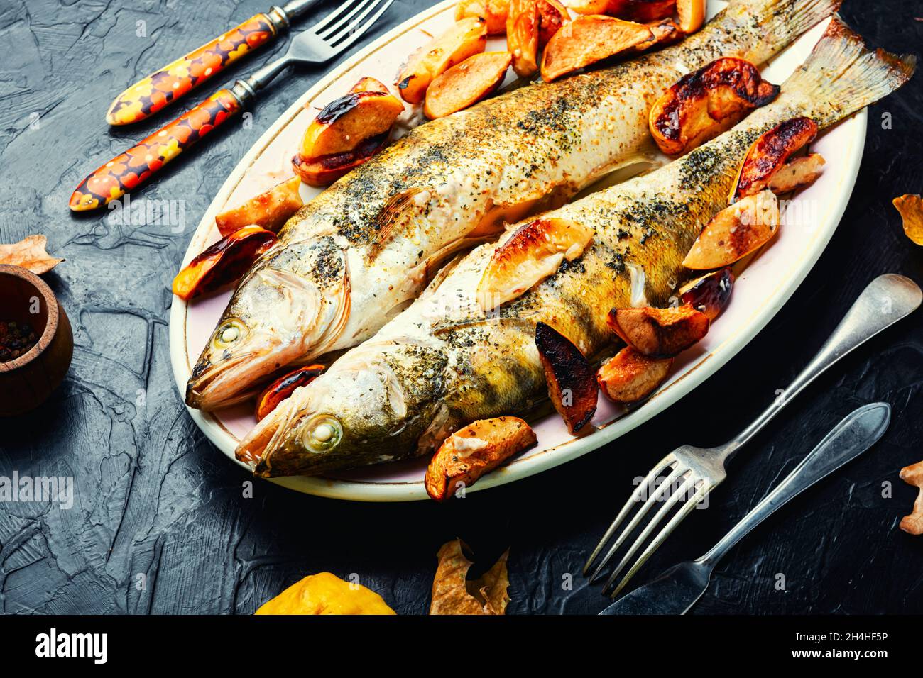 Fish pike perch roasted with quince and apple Stock Photo - Alamy