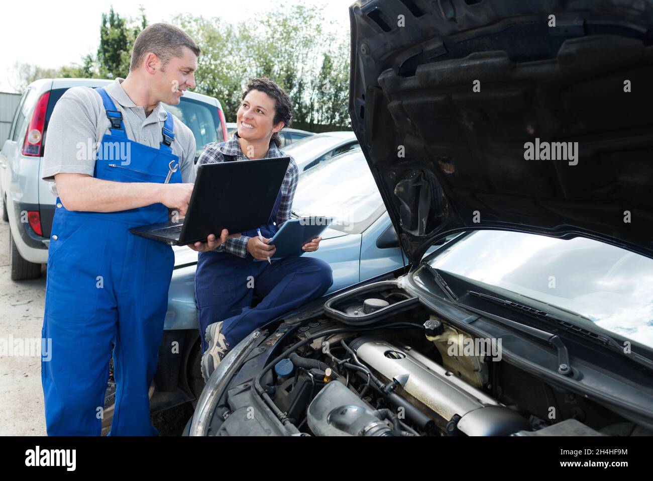 garage workers working on car diagnostic Stock Photo - Alamy