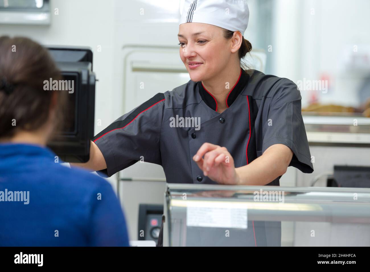 shop assistant talking to customer in a butchery Stock Photo - Alamy