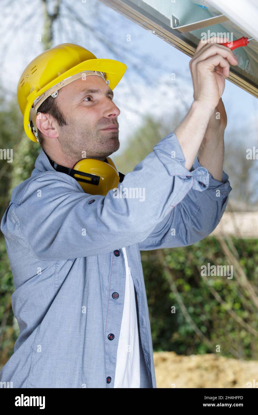 man fitting a pvc window outdoor Stock Photo - Alamy